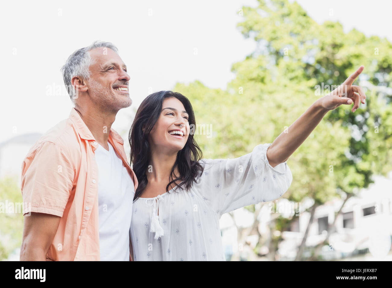 Happy woman pointing to man Stock Photo - Alamy