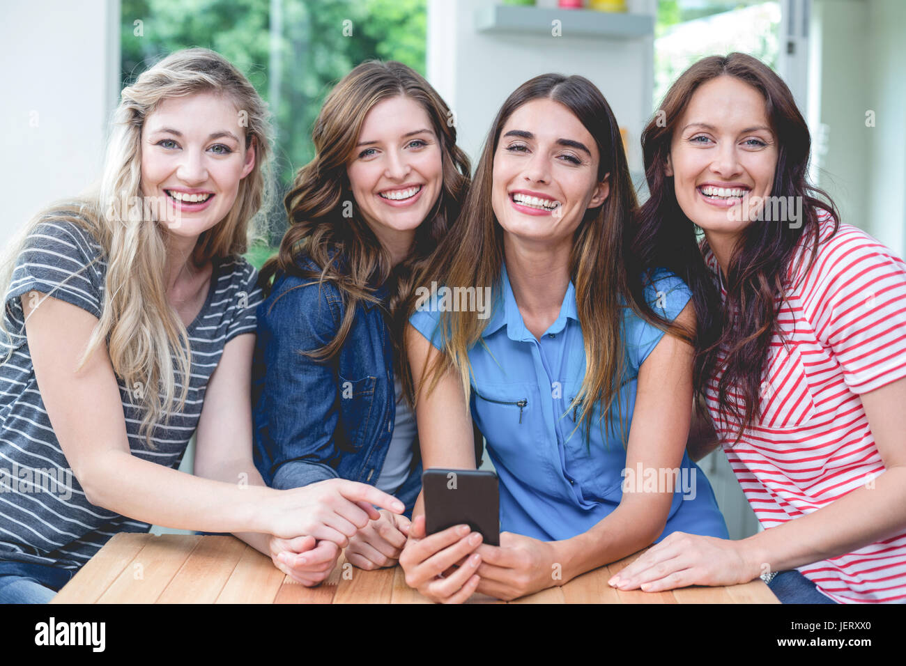 Beautiful women holding a mobile phone Stock Photo - Alamy