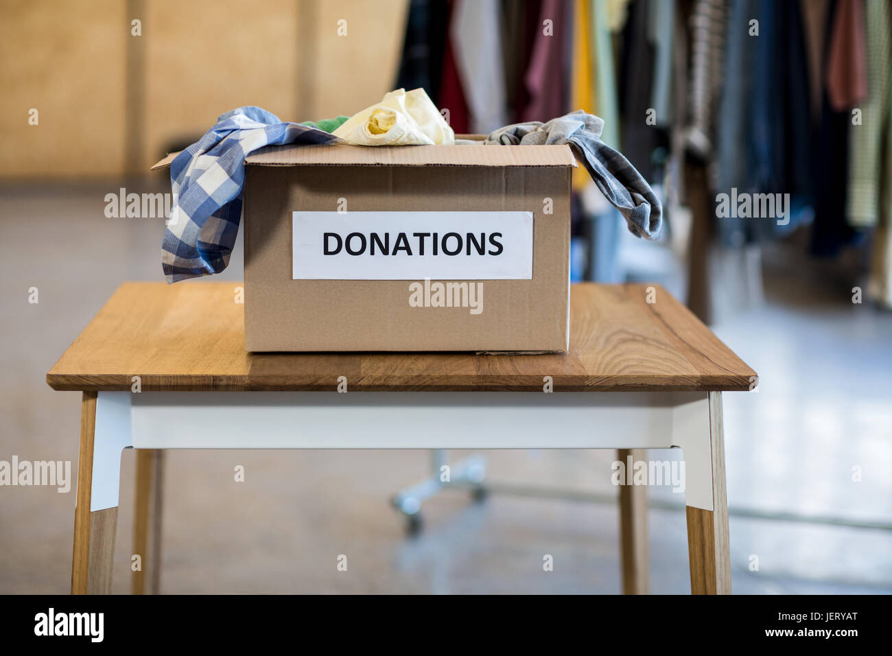 Donation box on a wooden table Stock Photo - Alamy