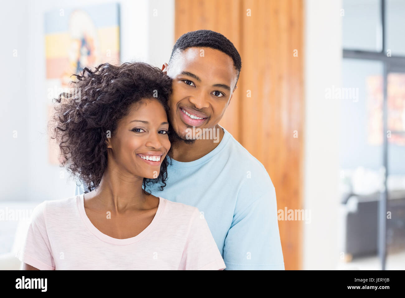 Happy couple embracing at home Stock Photo - Alamy