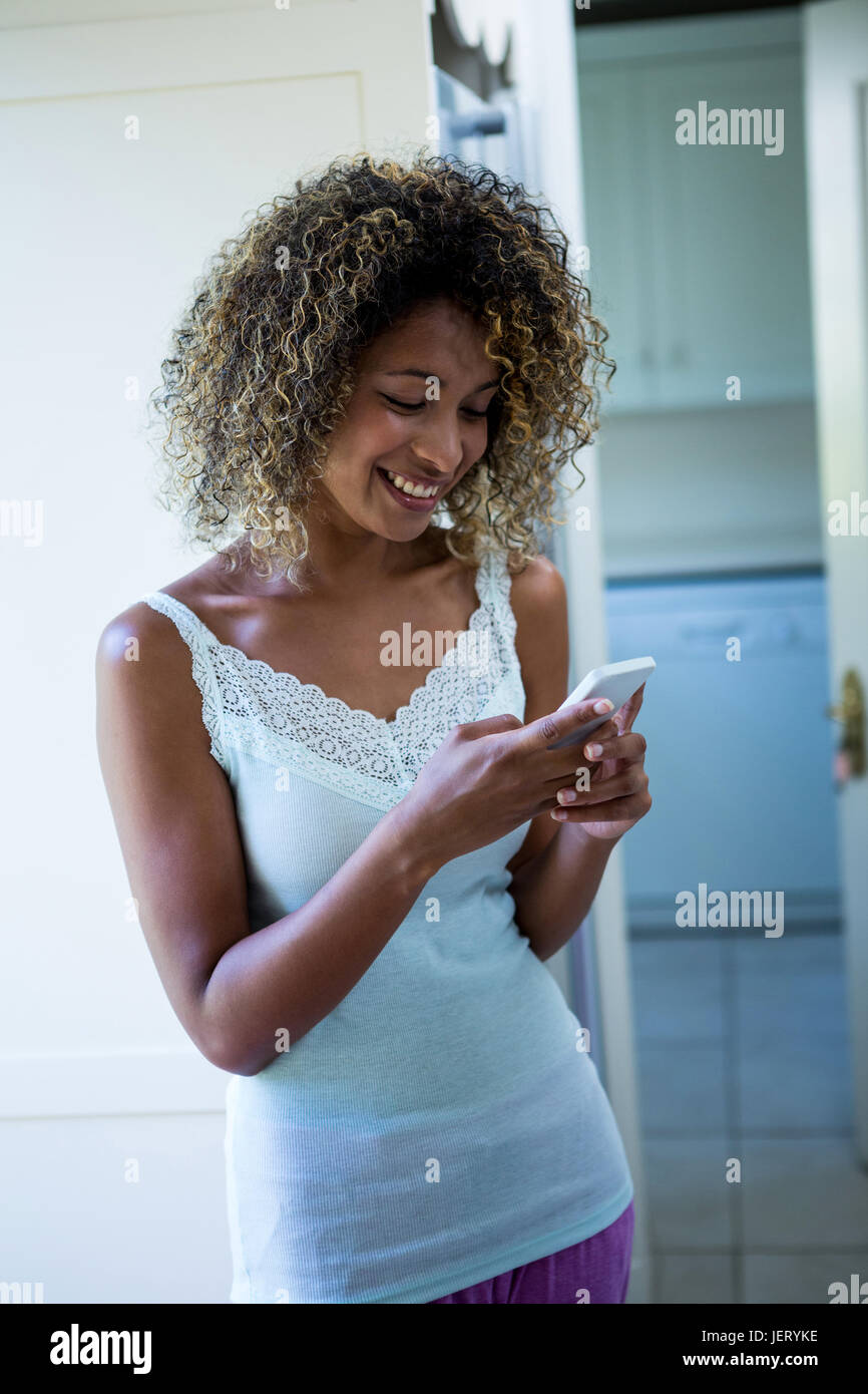 Young woman text messaging on phone Stock Photo - Alamy