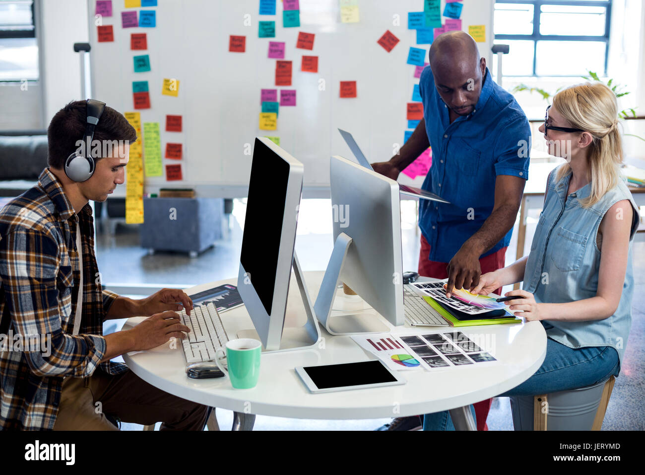Graphic designers working at their desk Stock Photo - Alamy