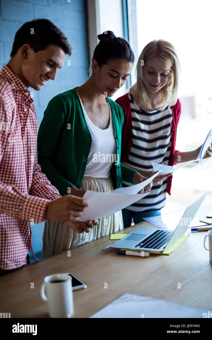 Colleagues discussing at their desk Stock Photo - Alamy