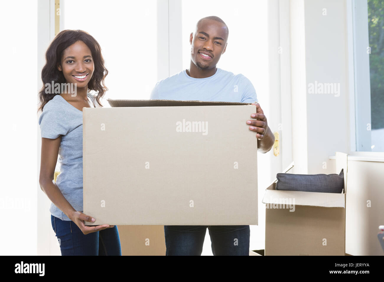 Young couple holding carton boxes Stock Photo - Alamy