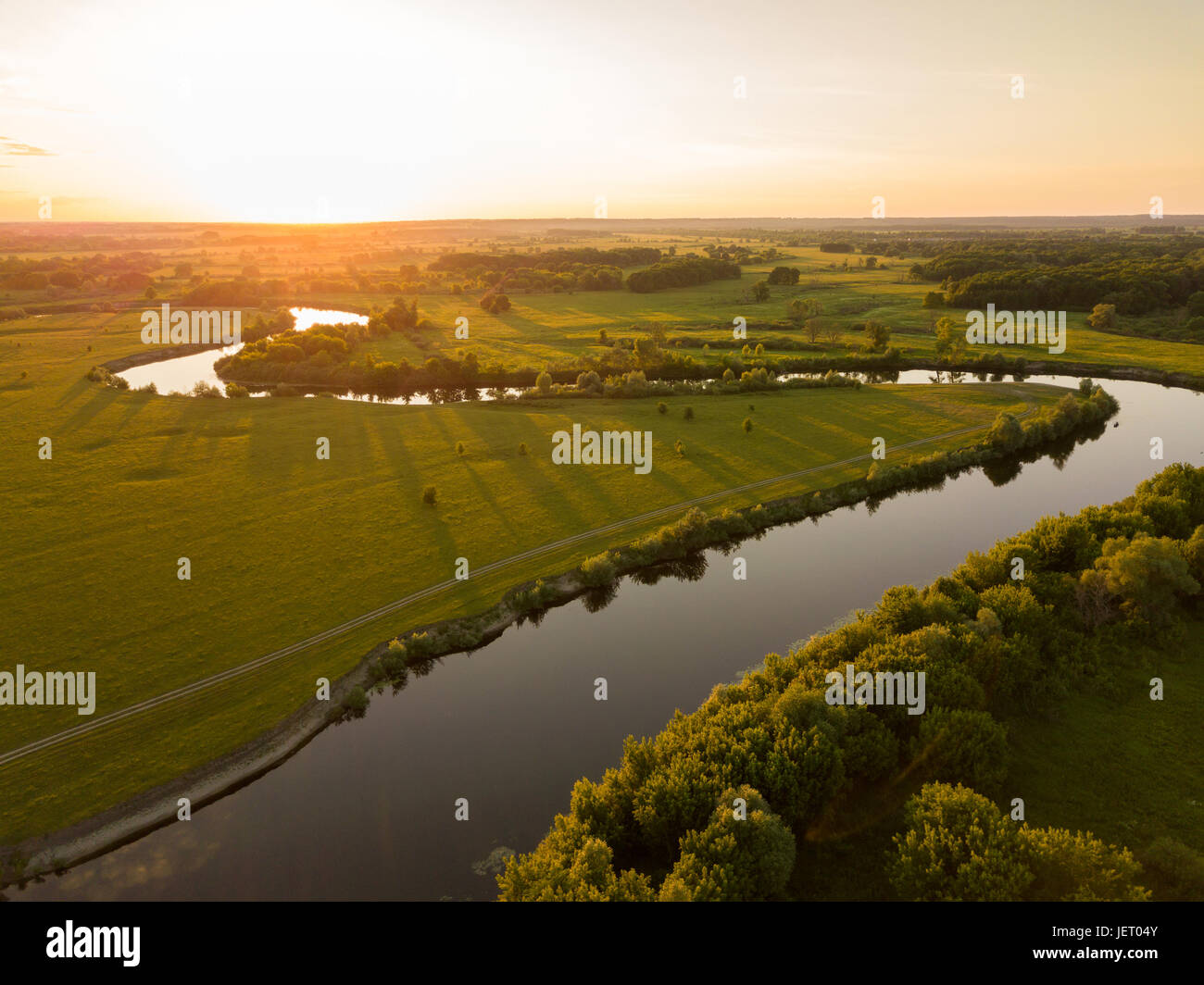 Top view of the Seim River (Ukraine), surrounded by trees and meadows ...