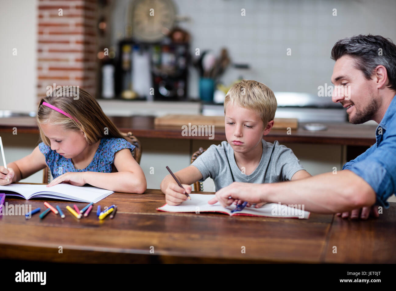 Father helping kids with their homework Stock Photo - Alamy