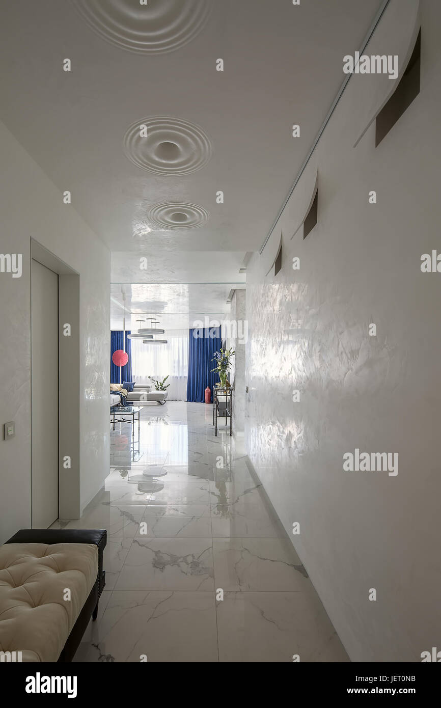 Light corridor in a modern style with textured walls and a tiled floor ...