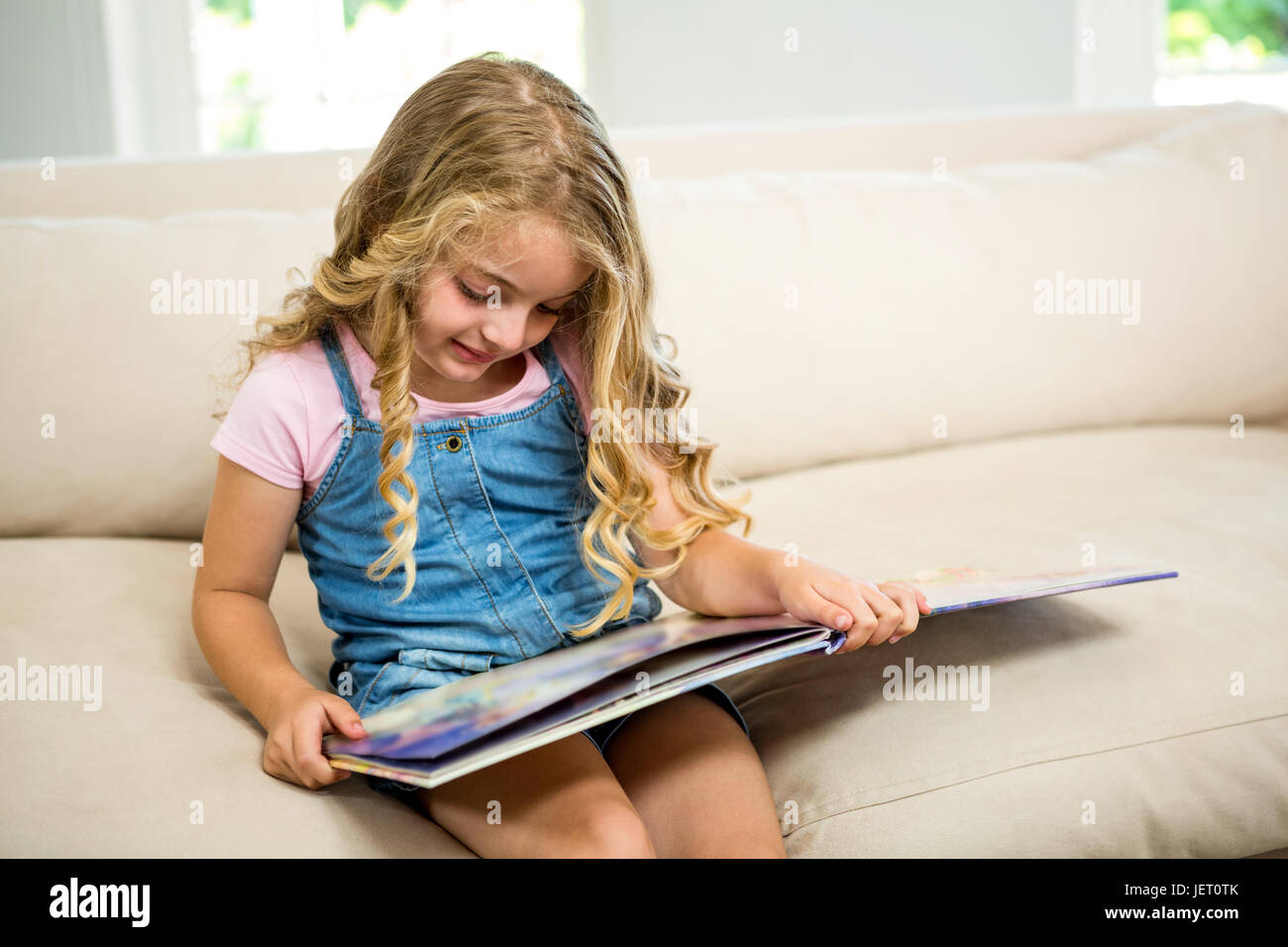 Smiling girl with picture book Stock Photo - Alamy