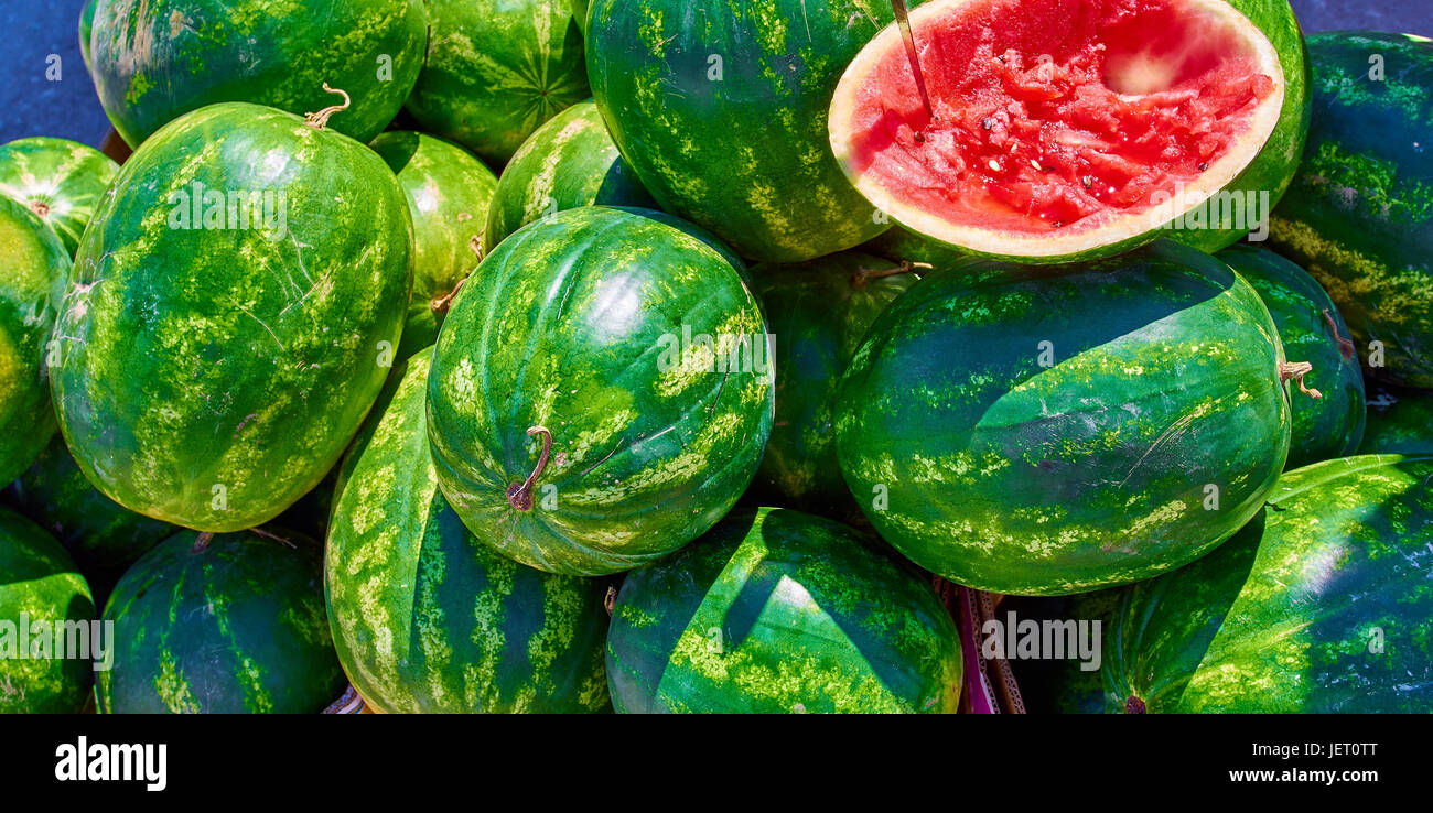 Big sweet green organic ripe watermelons. stacking watermelons ...