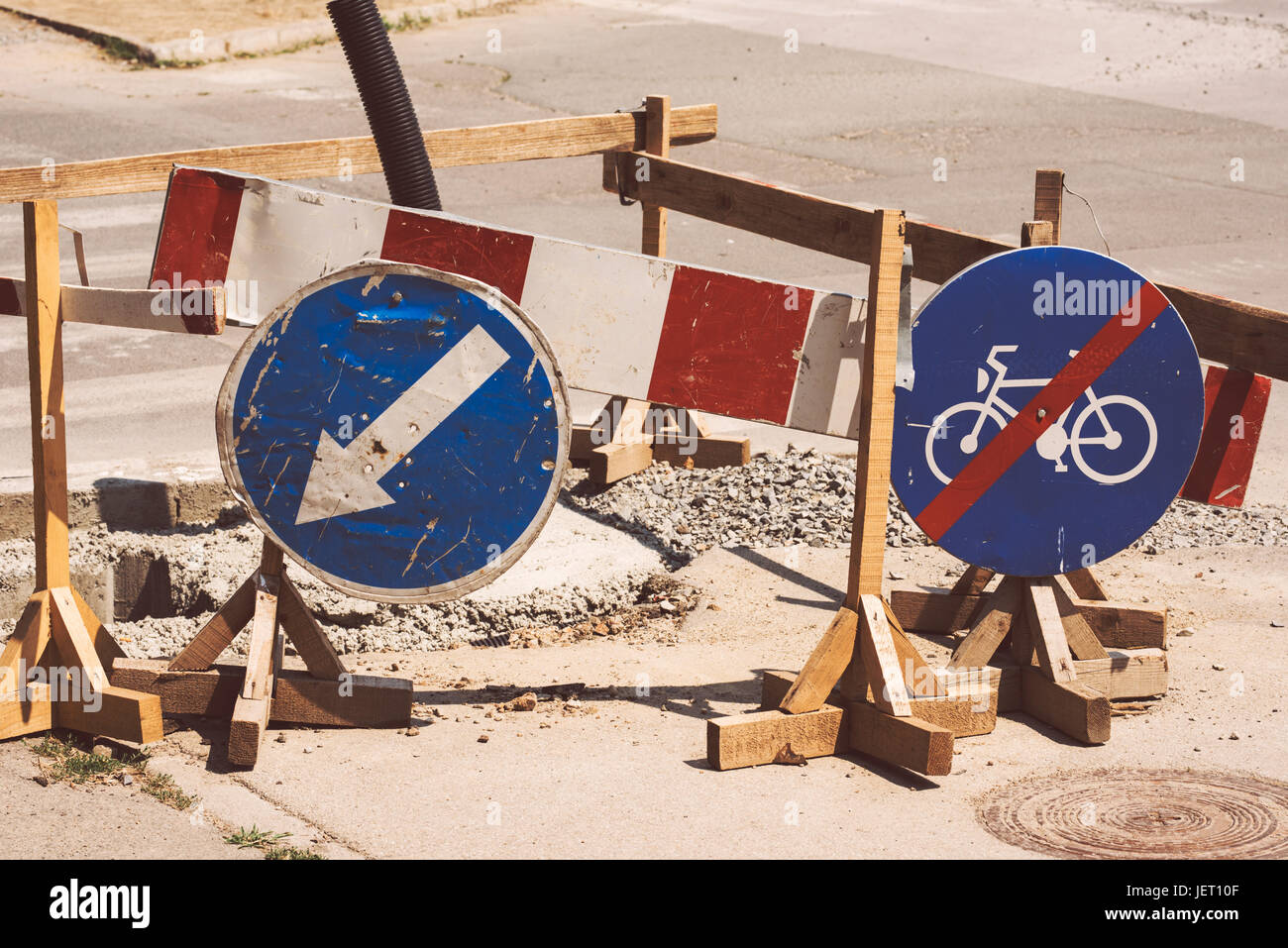 Road works and weather worn traffic signs, detour and bicycles lane ...