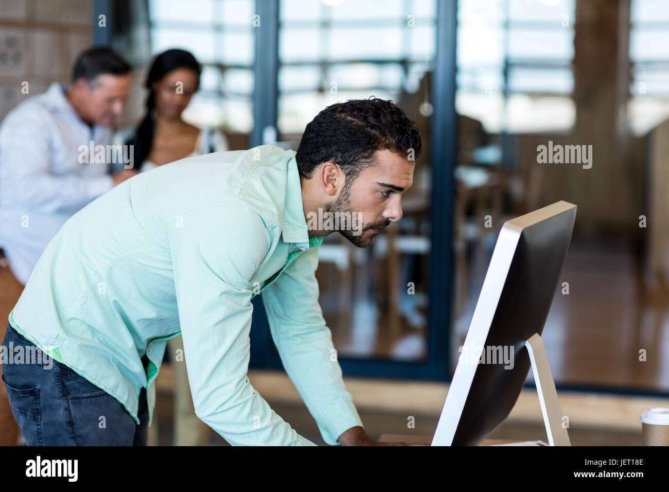 Young man working on computer Stock Photo - Alamy