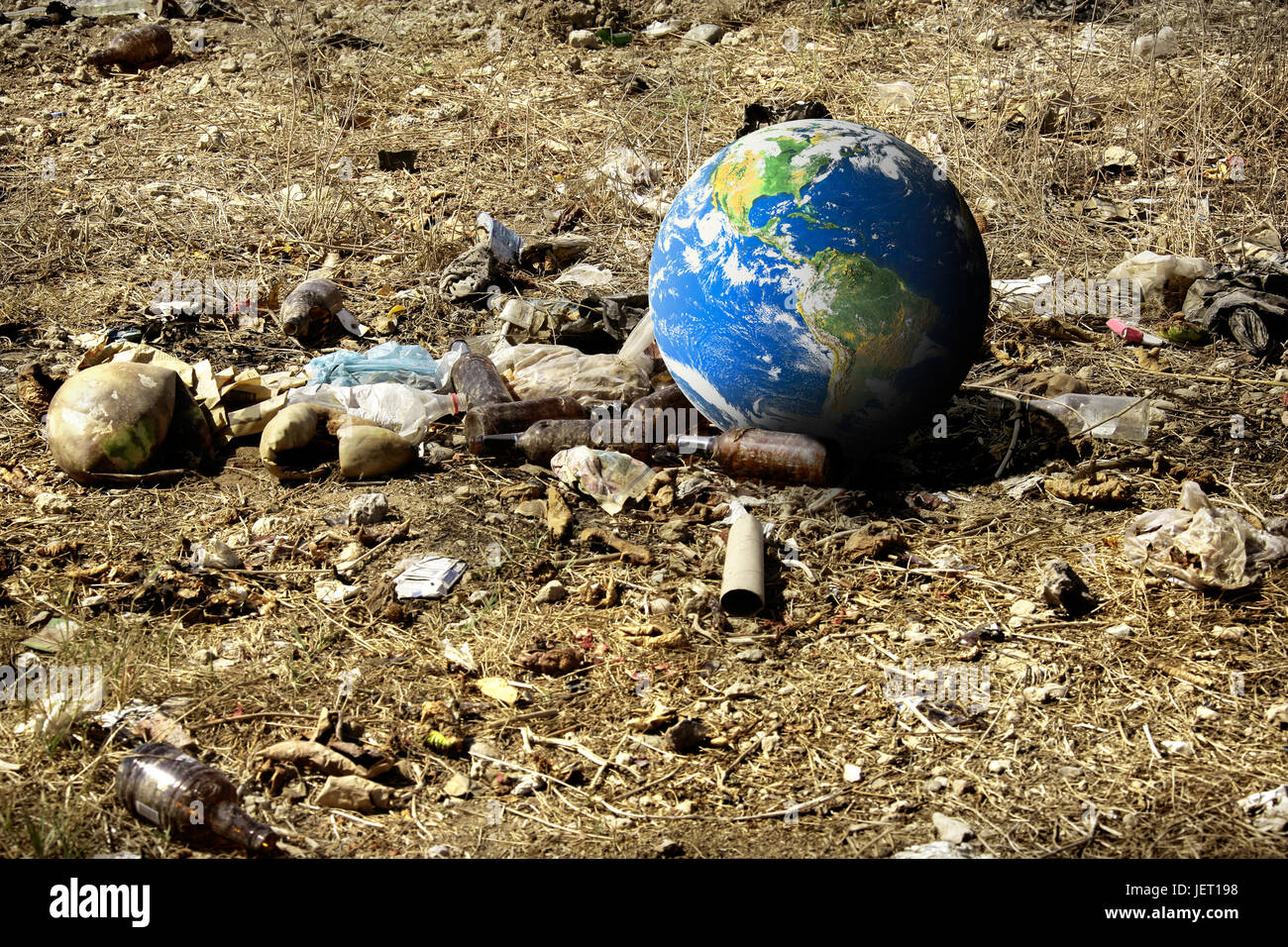 Conceptual image of globe on dirty landscape. Elements of this image ...