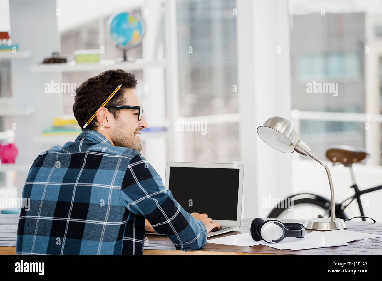 Young man working at his desk Stock Photo - Alamy