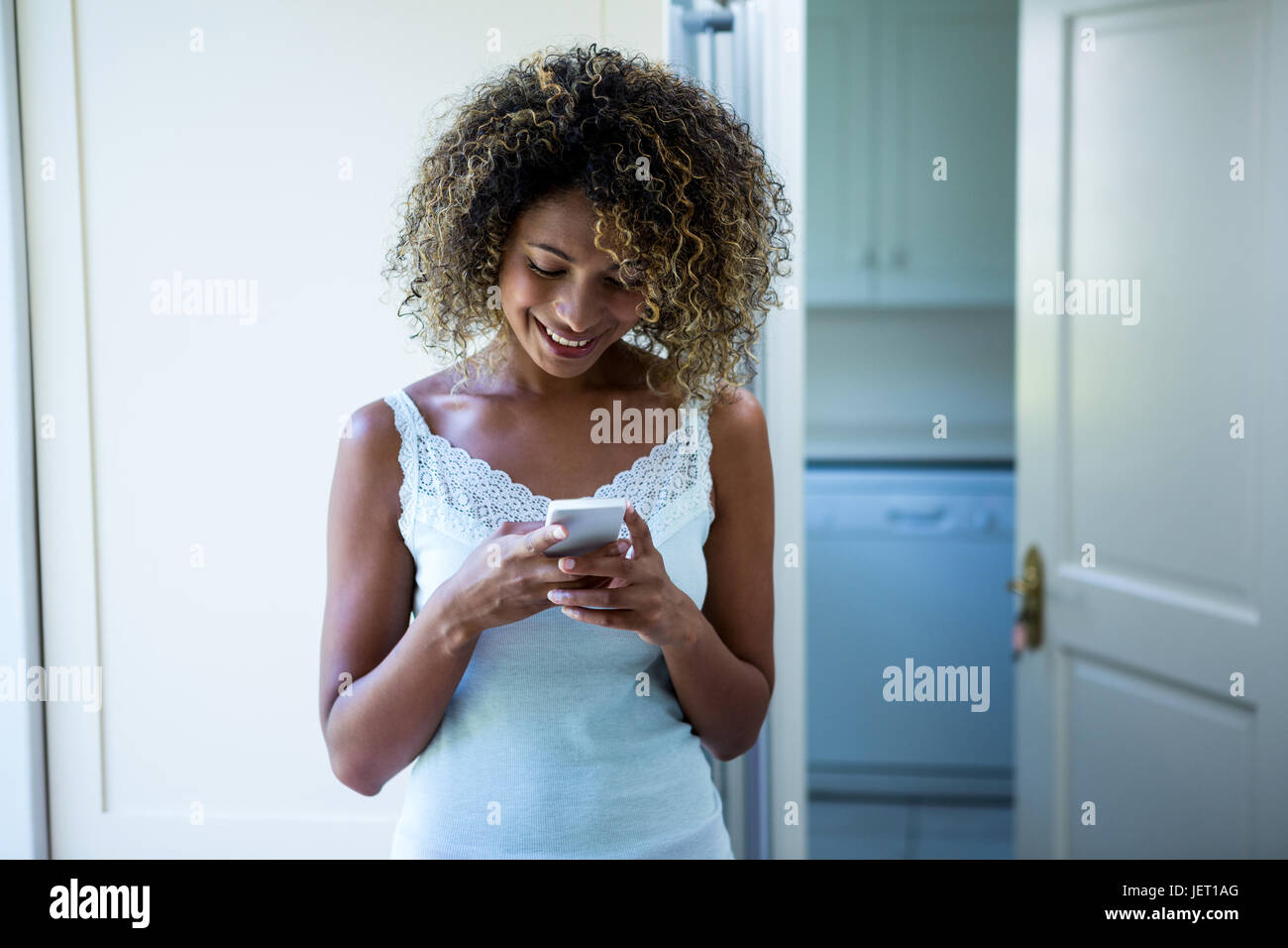 Young woman text messaging on phone Stock Photo - Alamy