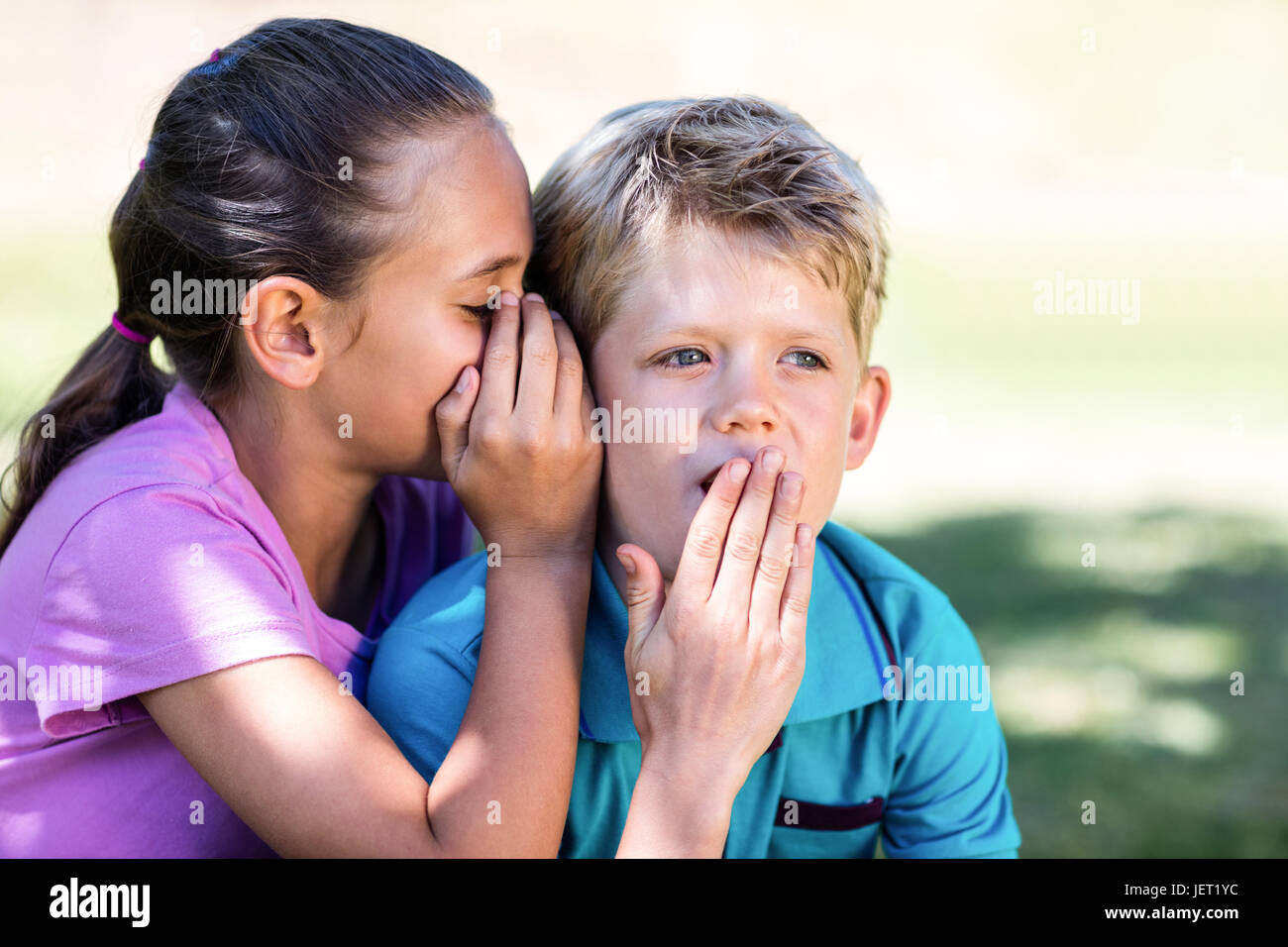 Child whispering in her ear hi-res stock photography and images - Alamy