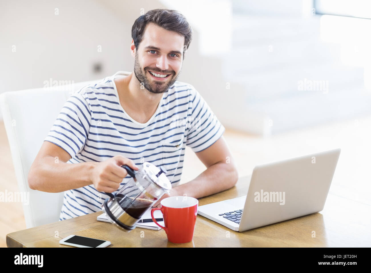 Handsome man pouring coffee hi-res stock photography and images - Alamy