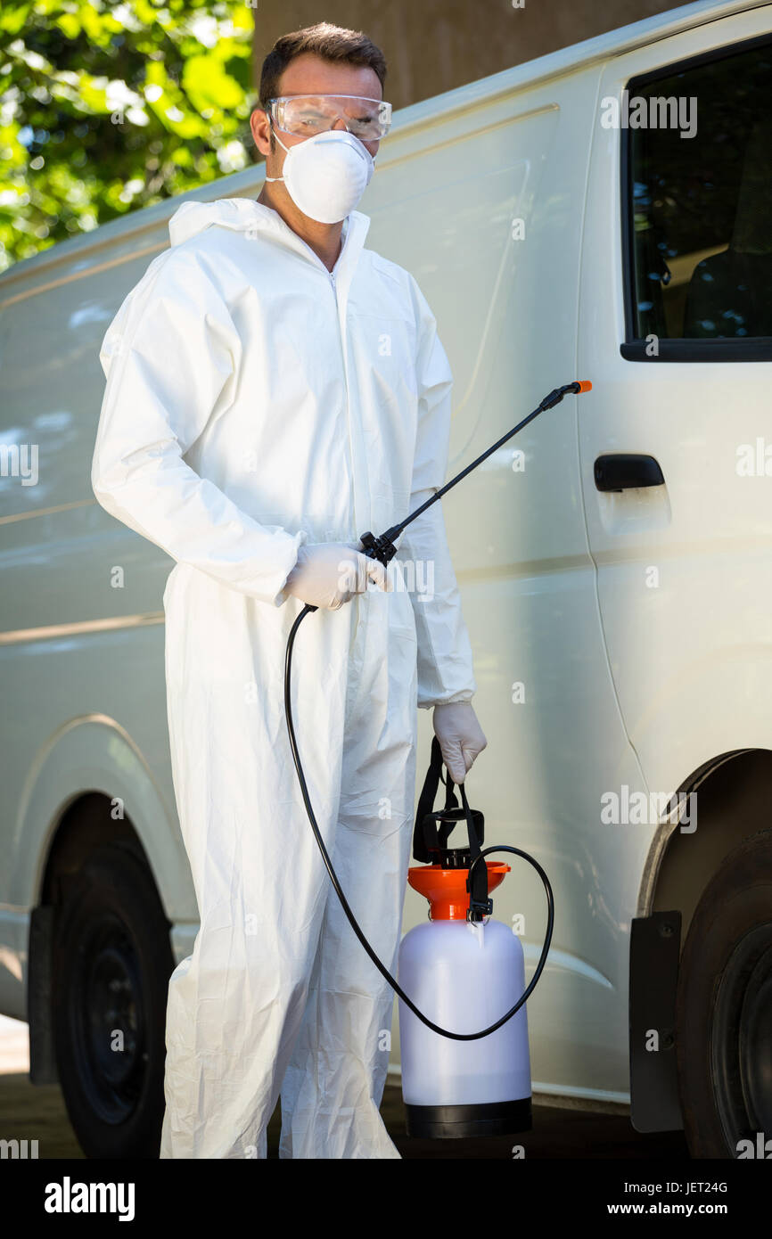 Pest control man standing next to a van Stock Photo - Alamy
