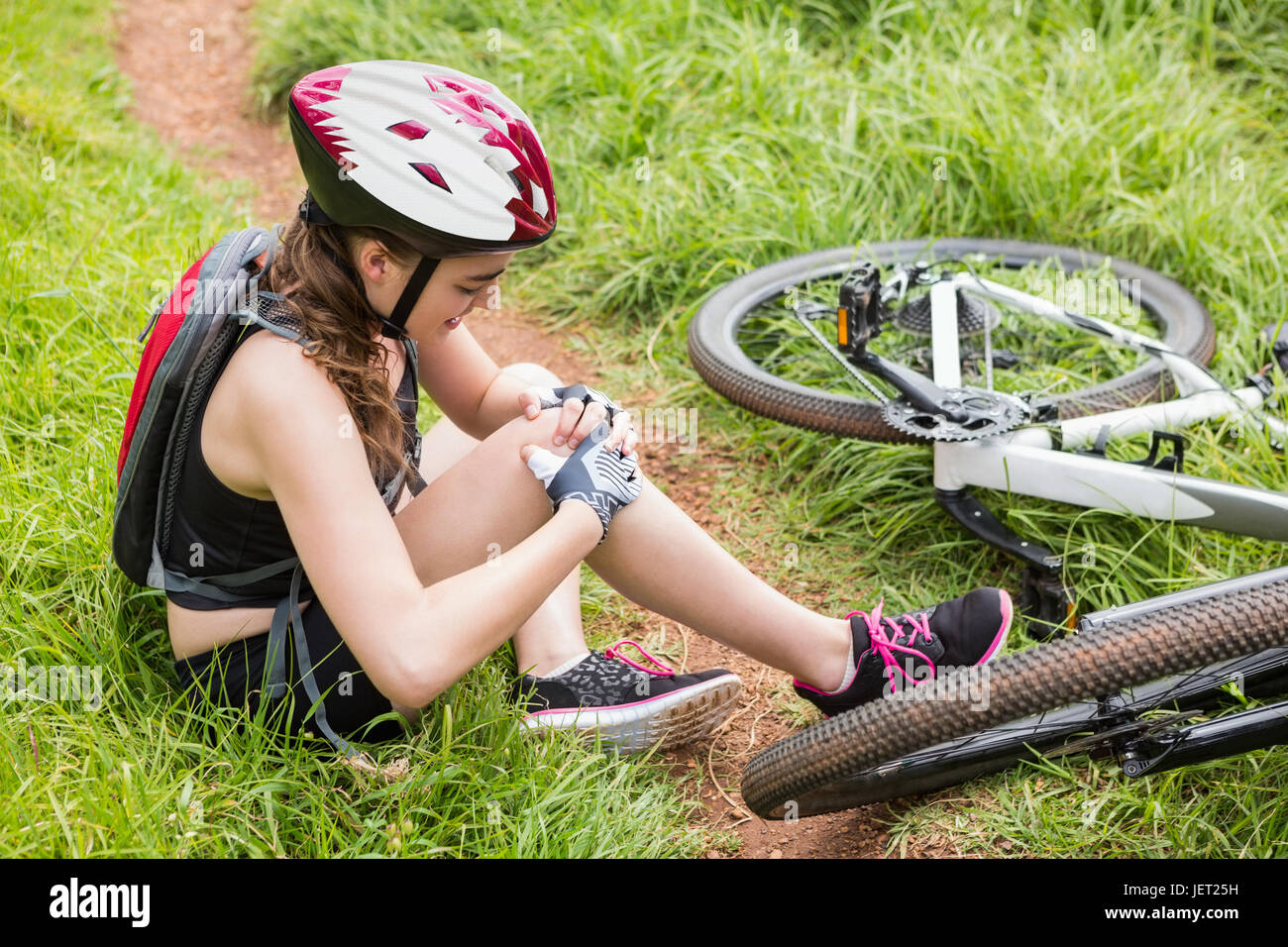 Woman hurting her leg Stock Photo - Alamy