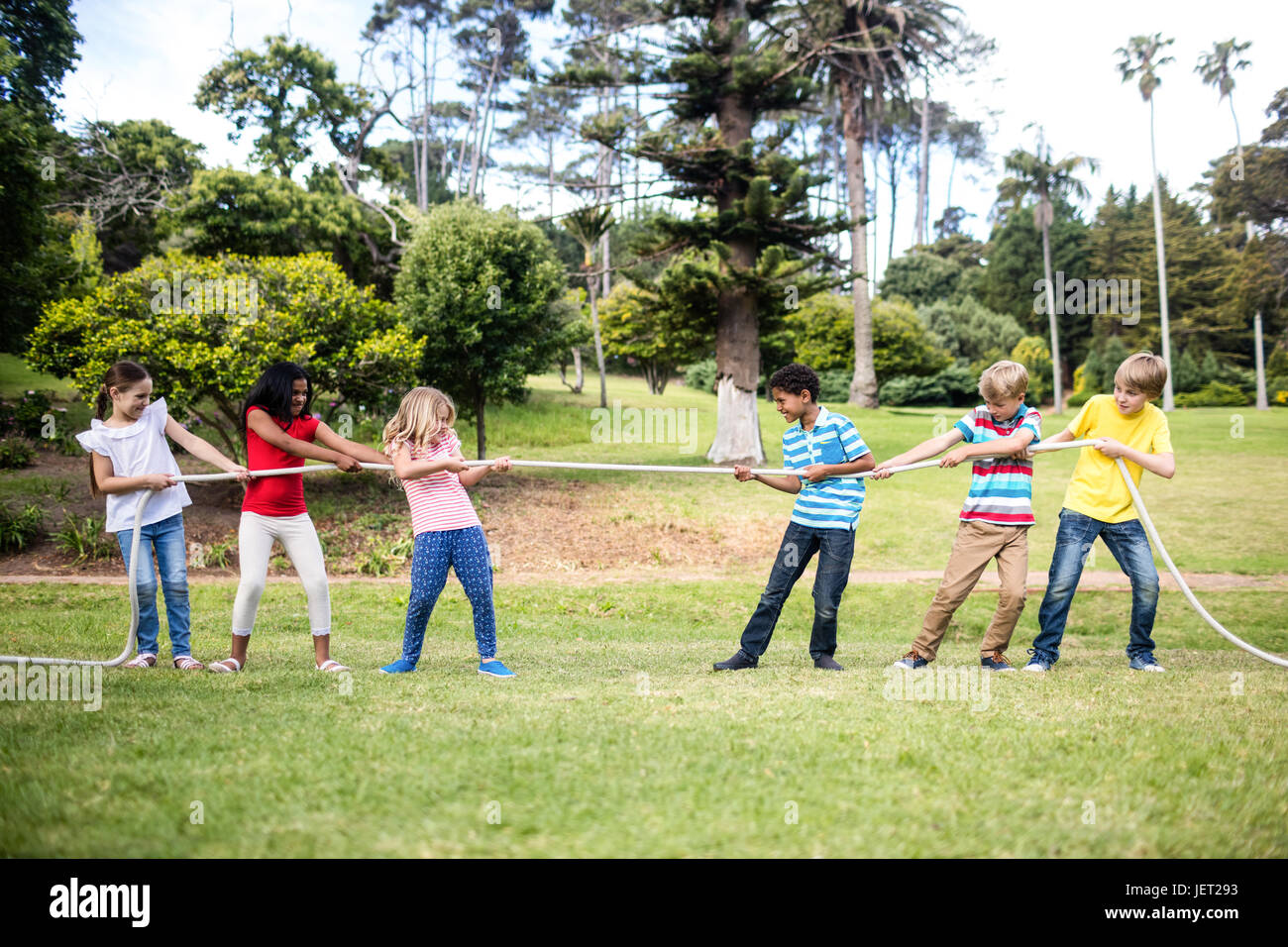 Children pulling a rope in tug of war Stock Photo - Alamy