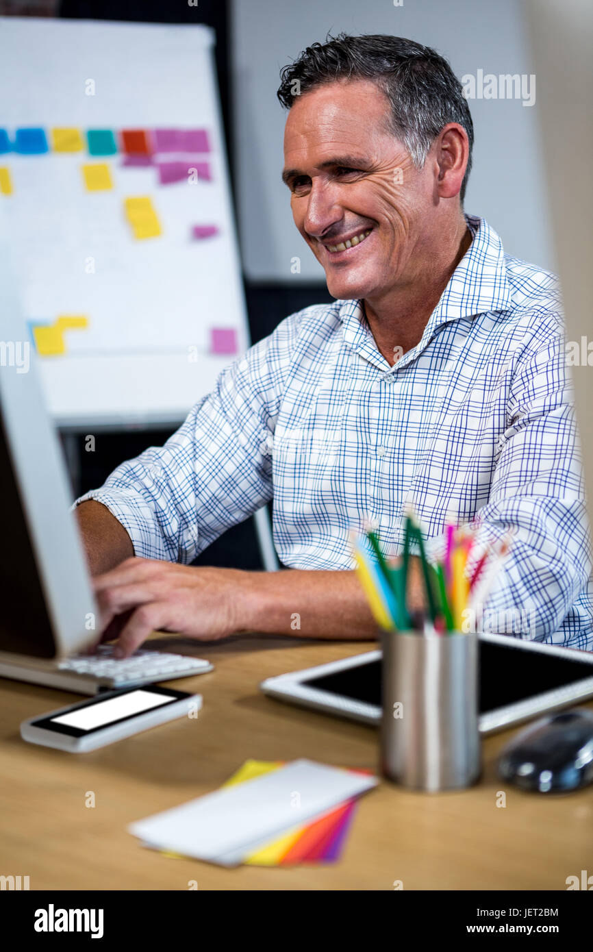 Man working on computer Stock Photo - Alamy