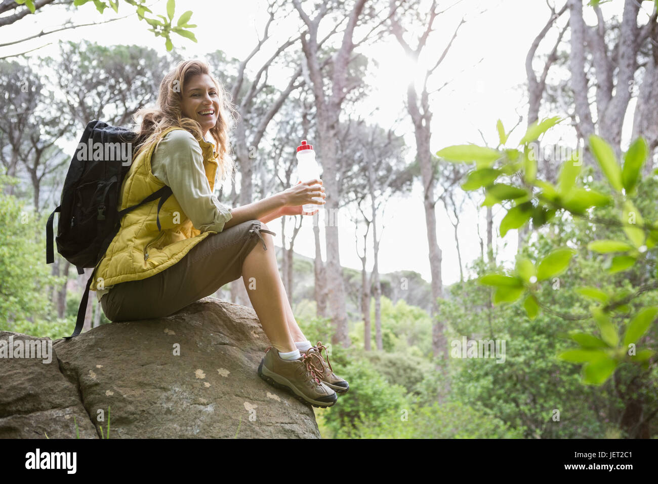 Woman sitting on a stone Stock Photo - Alamy