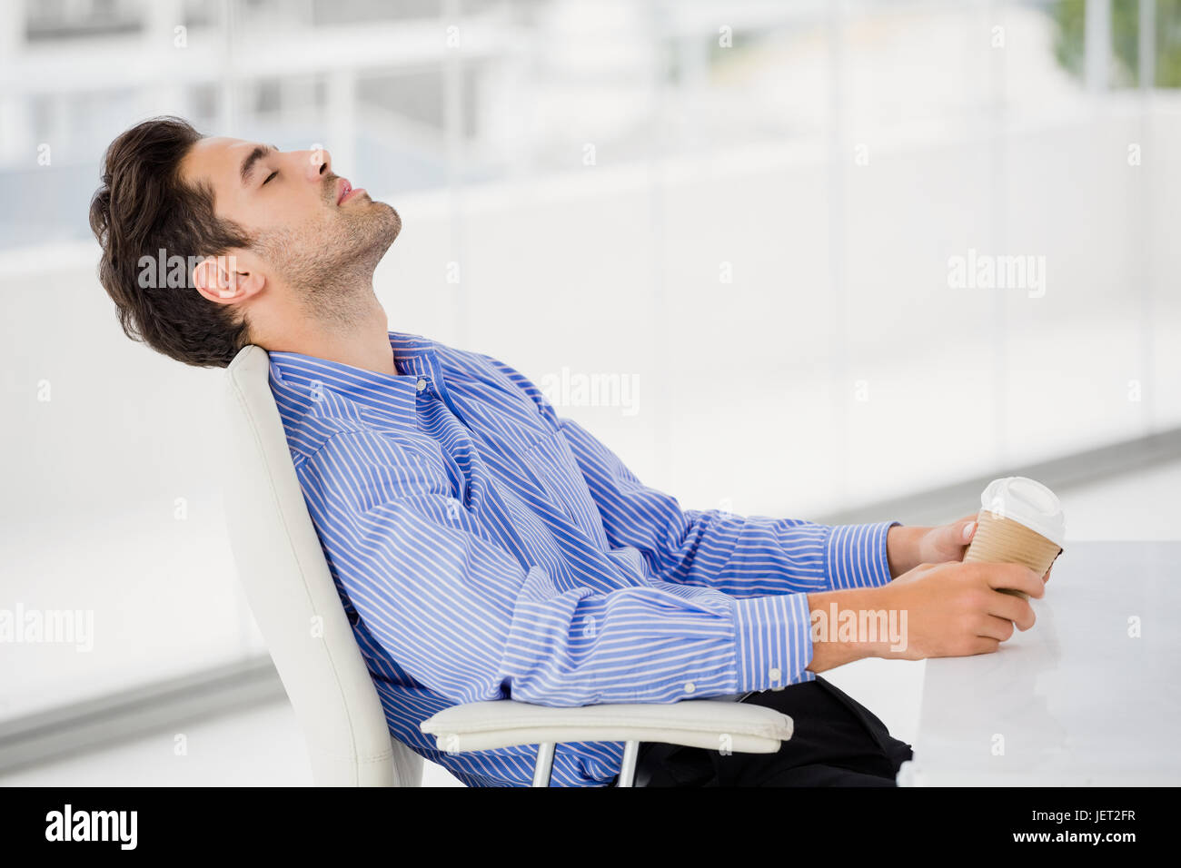 Businessman relaxing on chair hi-res stock photography and images - Alamy