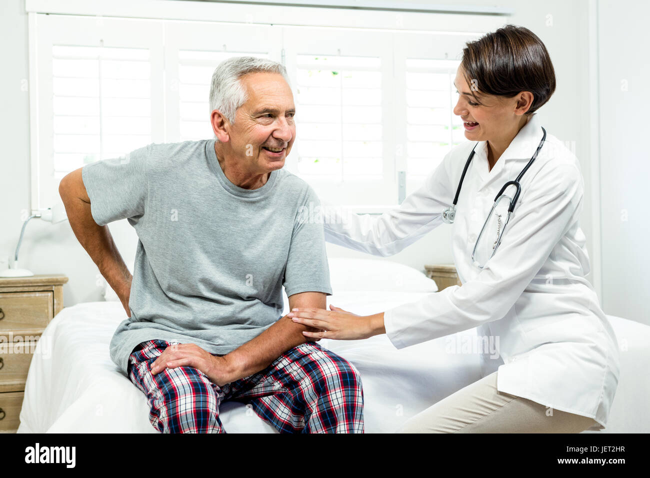 Female doctor touching senior hi-res stock photography and images - Alamy