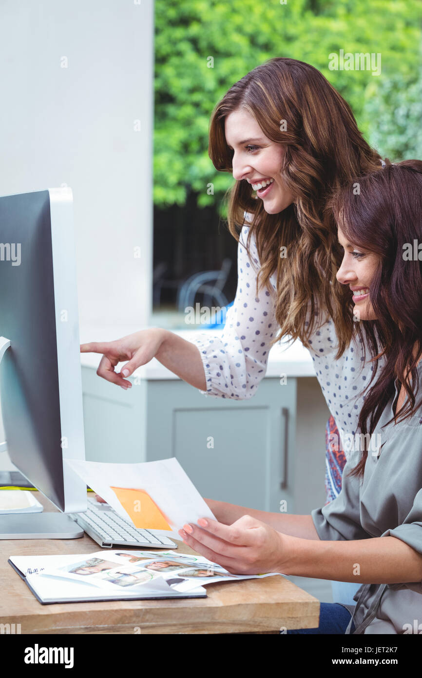 Two beautiful woman using computer Stock Photo - Alamy