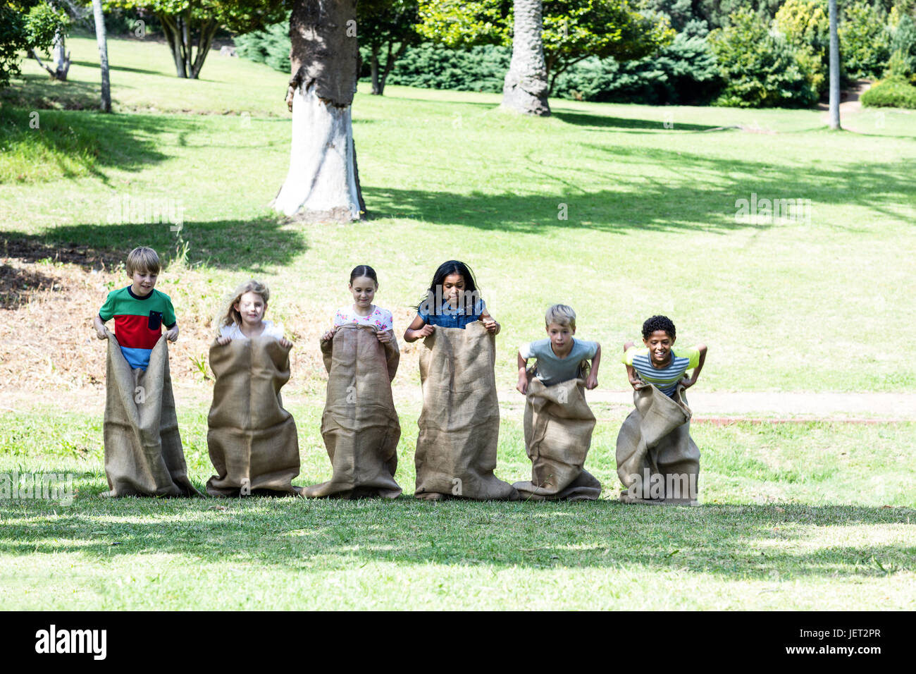 Children jumping sack race hi-res stock photography and images - Alamy