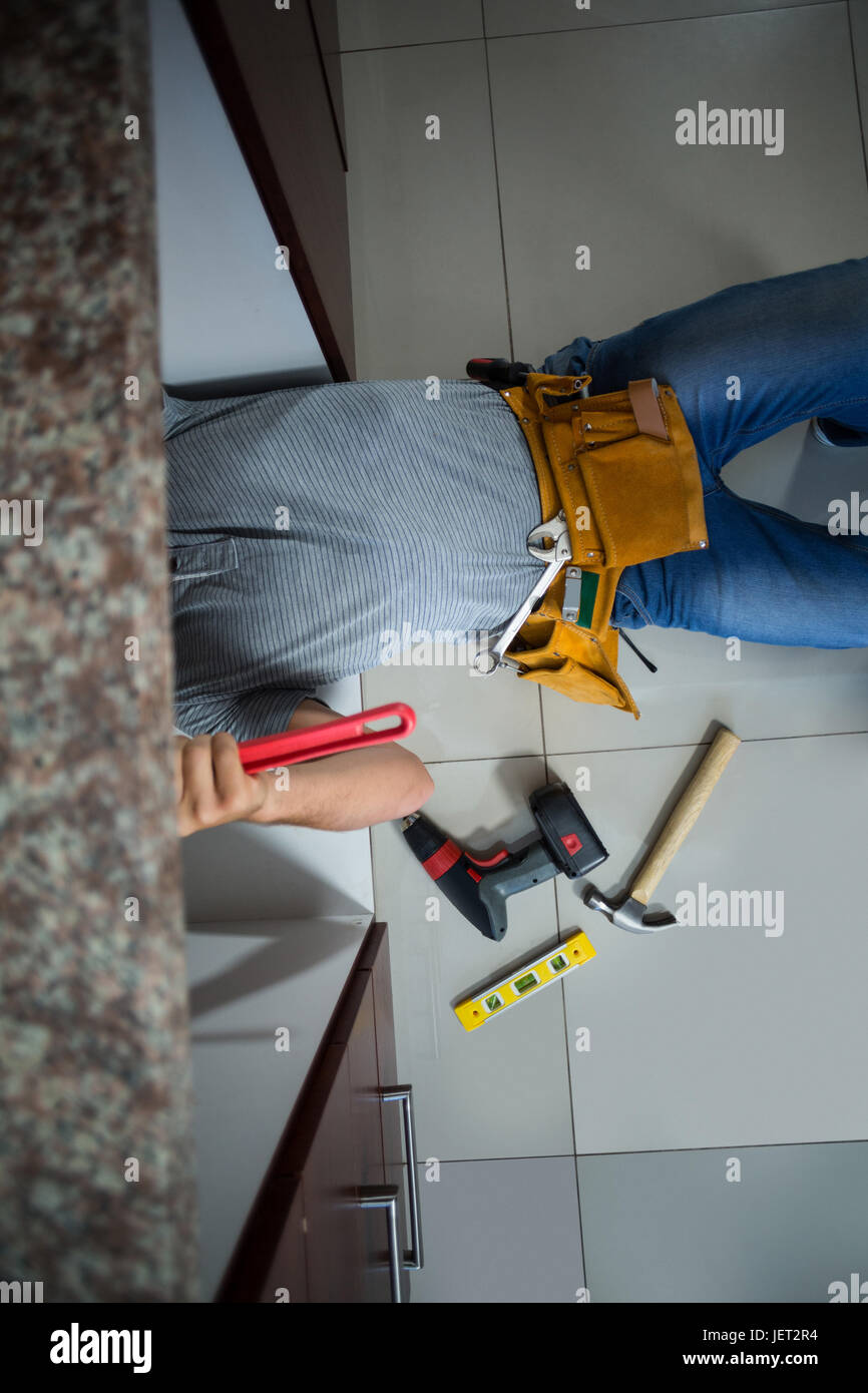 Low section of man working while lying Stock Photo - Alamy
