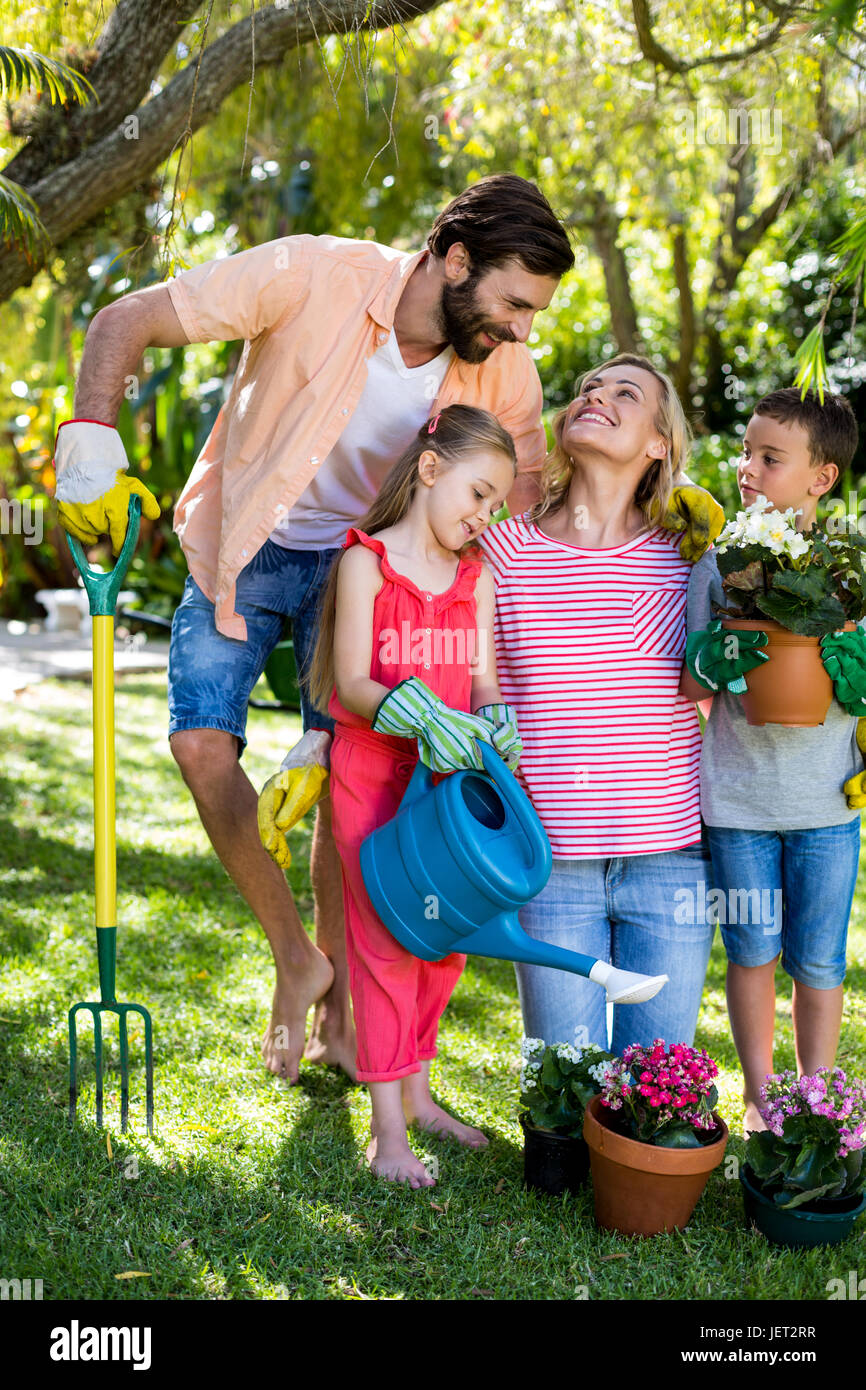 Parents with children gardening in yard Stock Photo - Alamy