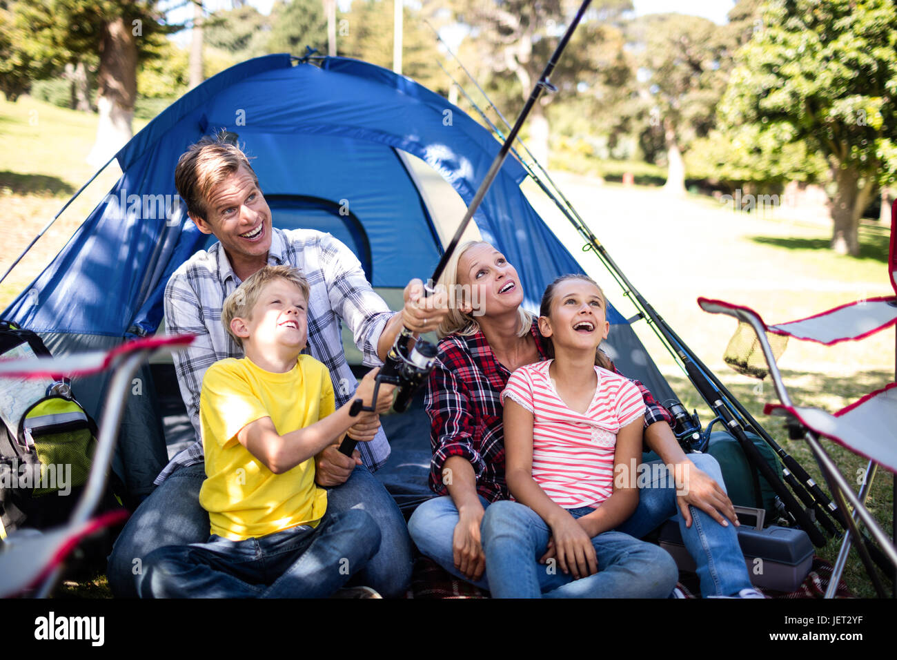 Family fishing outside their tent Stock Photo - Alamy