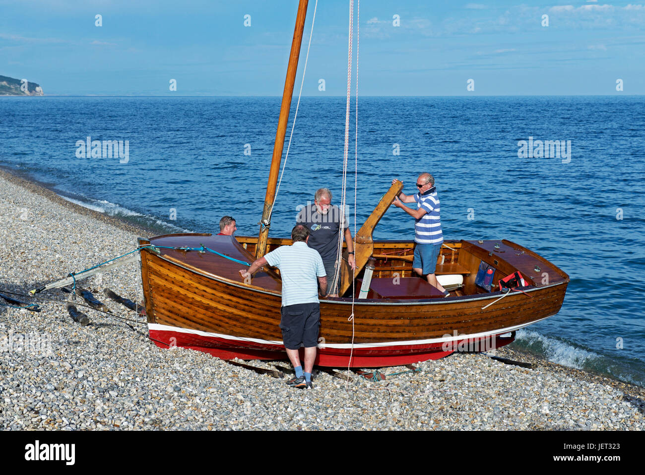 Men rigging boat (lugger) on the beach, Beer, Devon, England UK Stock ...