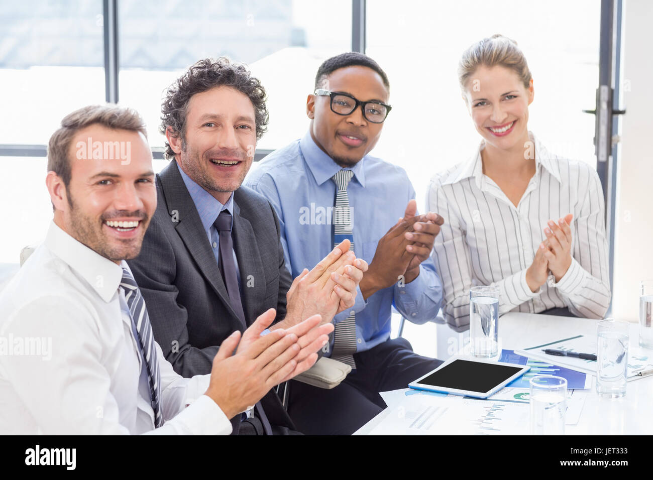 Businesspeople applauding while in a meeting Stock Photo - Alamy