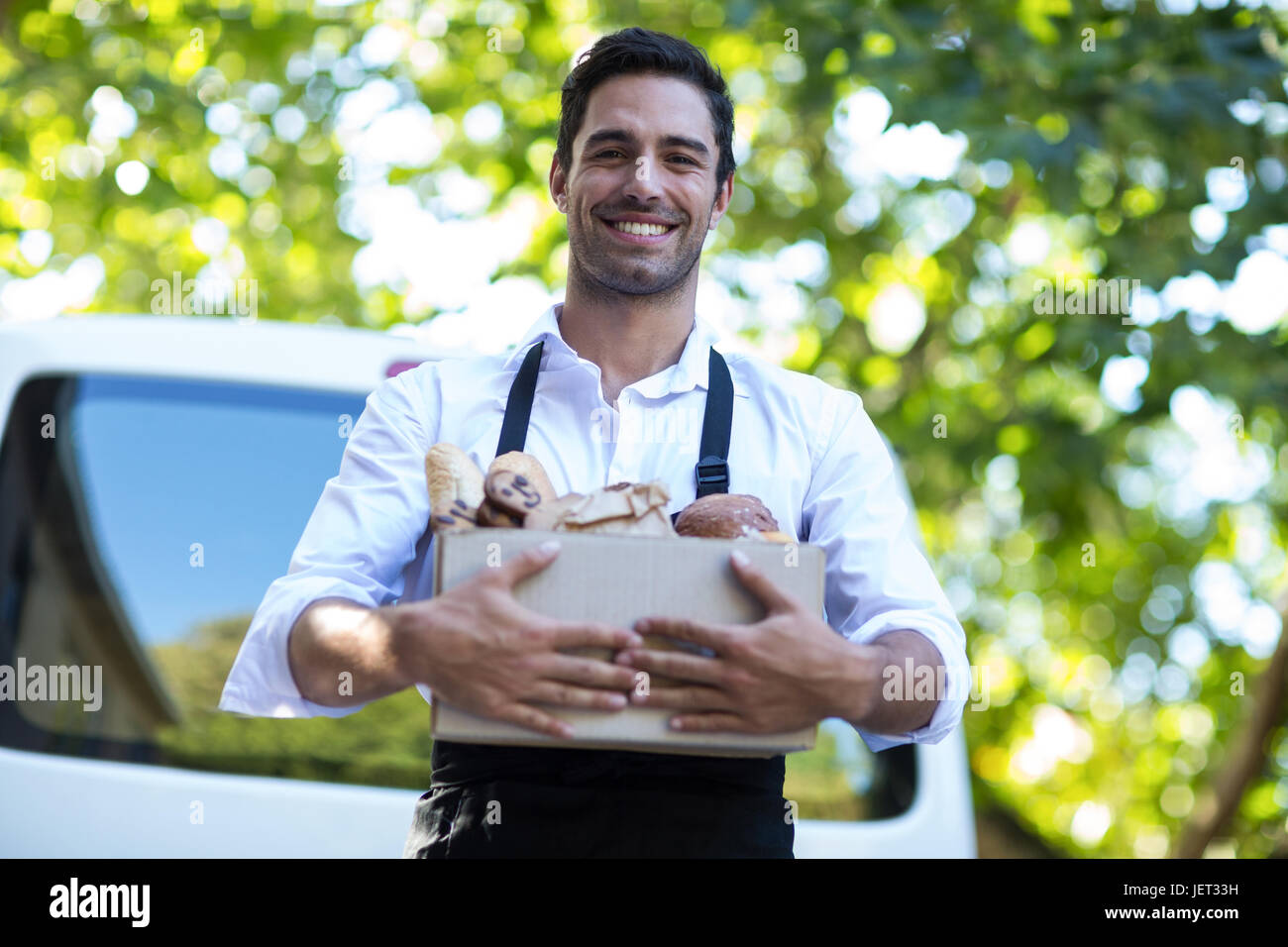 Portrait of happy delivery person Stock Photo - Alamy