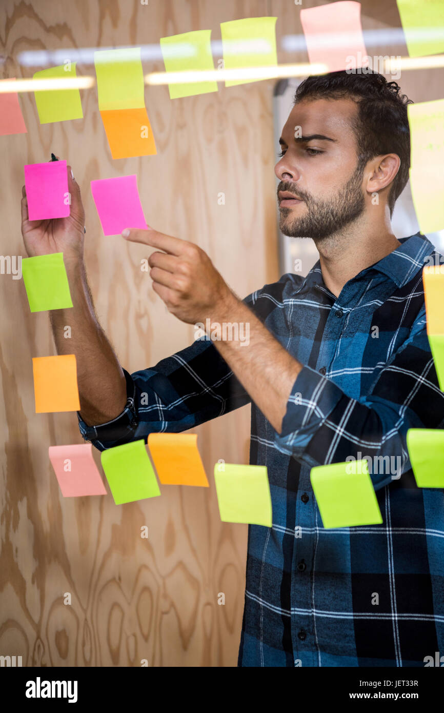 Man writing on sticky notes Stock Photo - Alamy