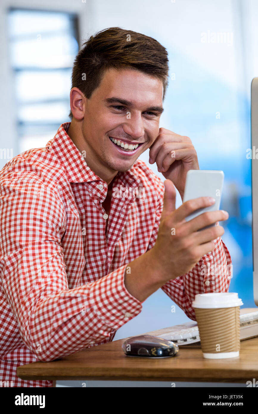 Happy man looking at mobile phone Stock Photo - Alamy