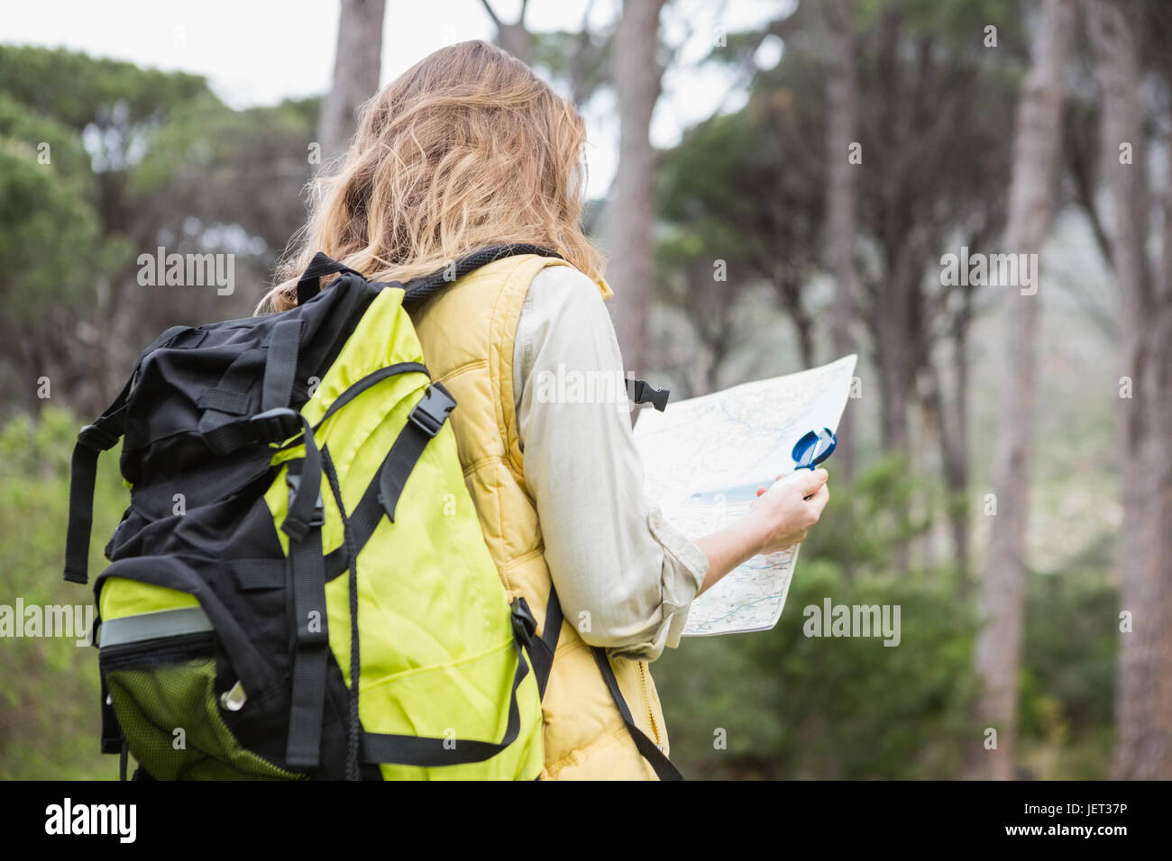 Woman with map and compass Stock Photo - Alamy