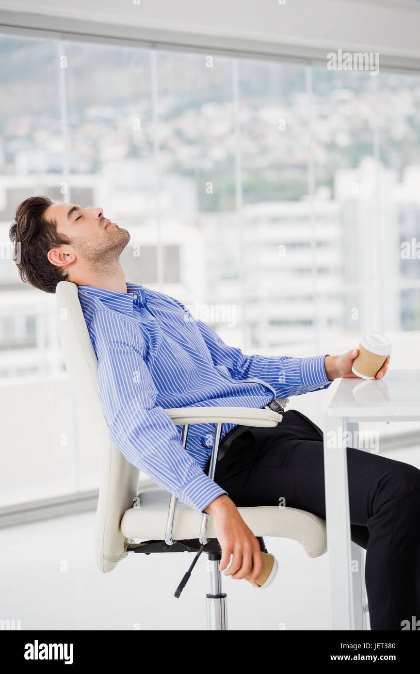 Businessman relaxing on chair hi-res stock photography and images - Alamy