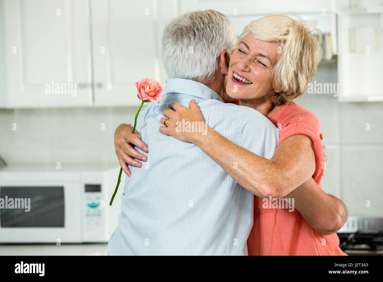 Smiling senior woman hugging man Stock Photo - Alamy