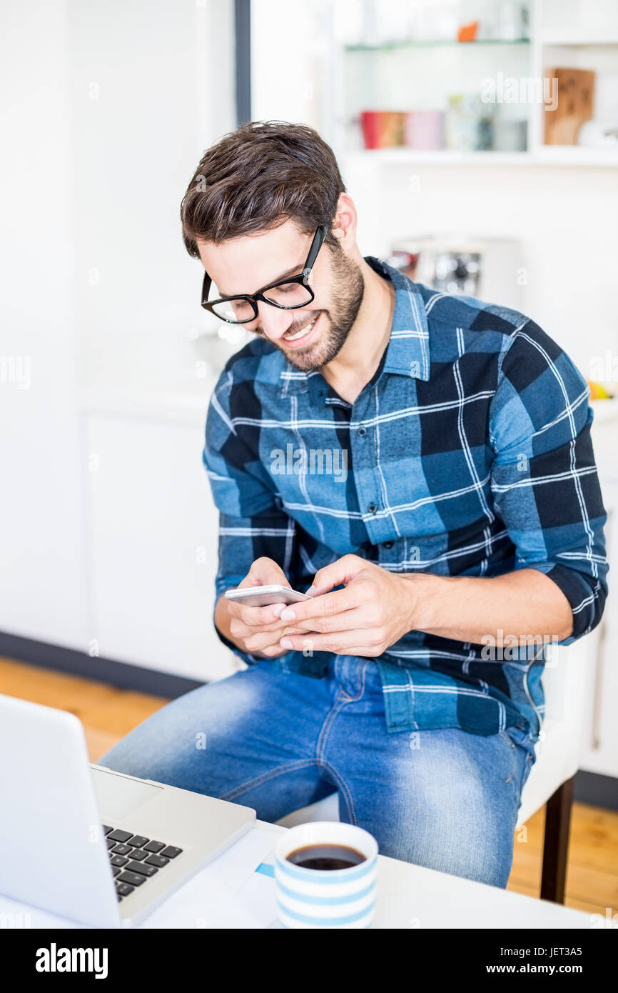 Cute nerd texting on smartphone Stock Photo - Alamy