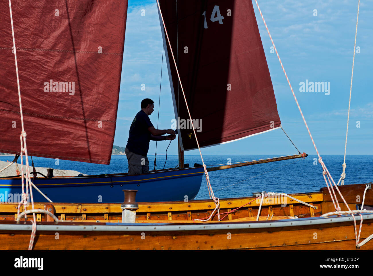 Man rigging boat (lugger) on the beach, Beer, Devon, England UK Stock ...
