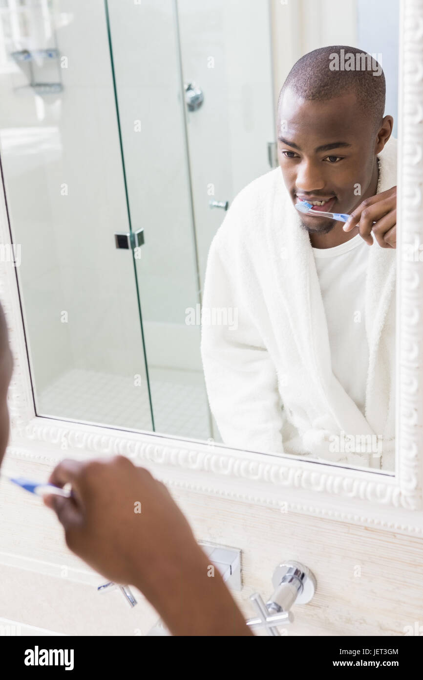 Young man brushing his teeth Stock Photo - Alamy