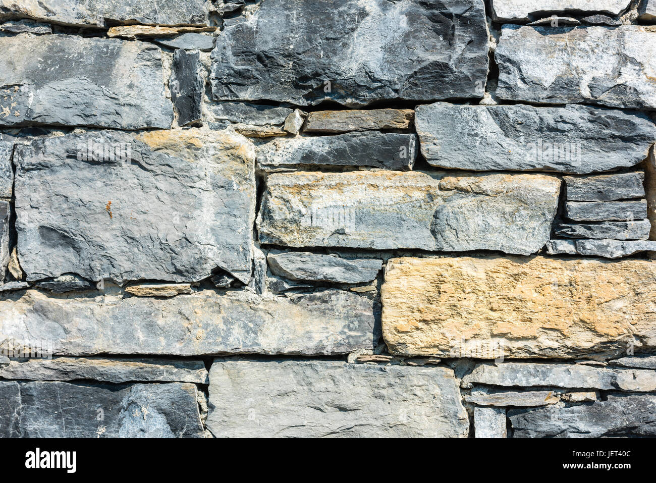 Rough stone wall great for backgrounds or textures Stock Photo - Alamy