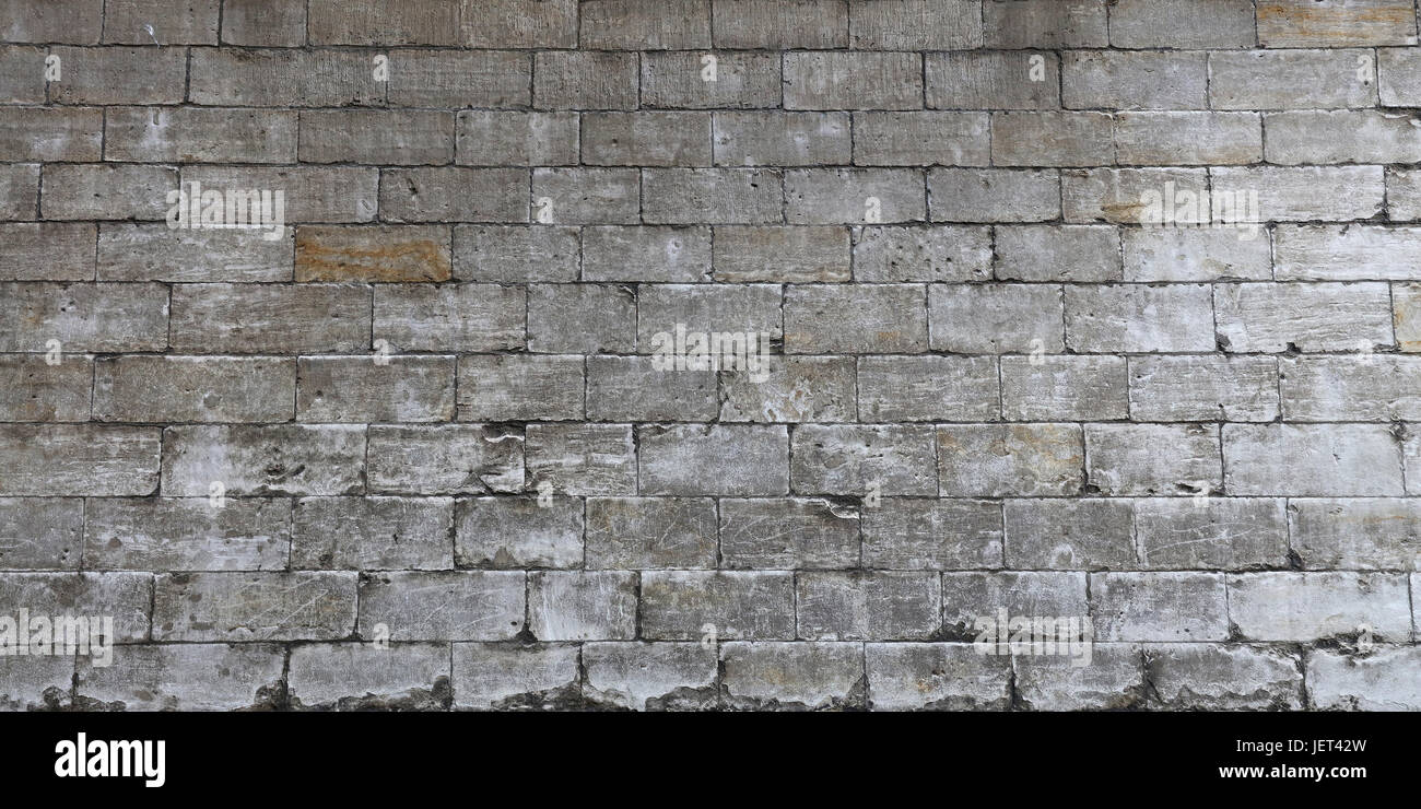 Wall of white and gray limestone travertine stone brick blocks, close ...