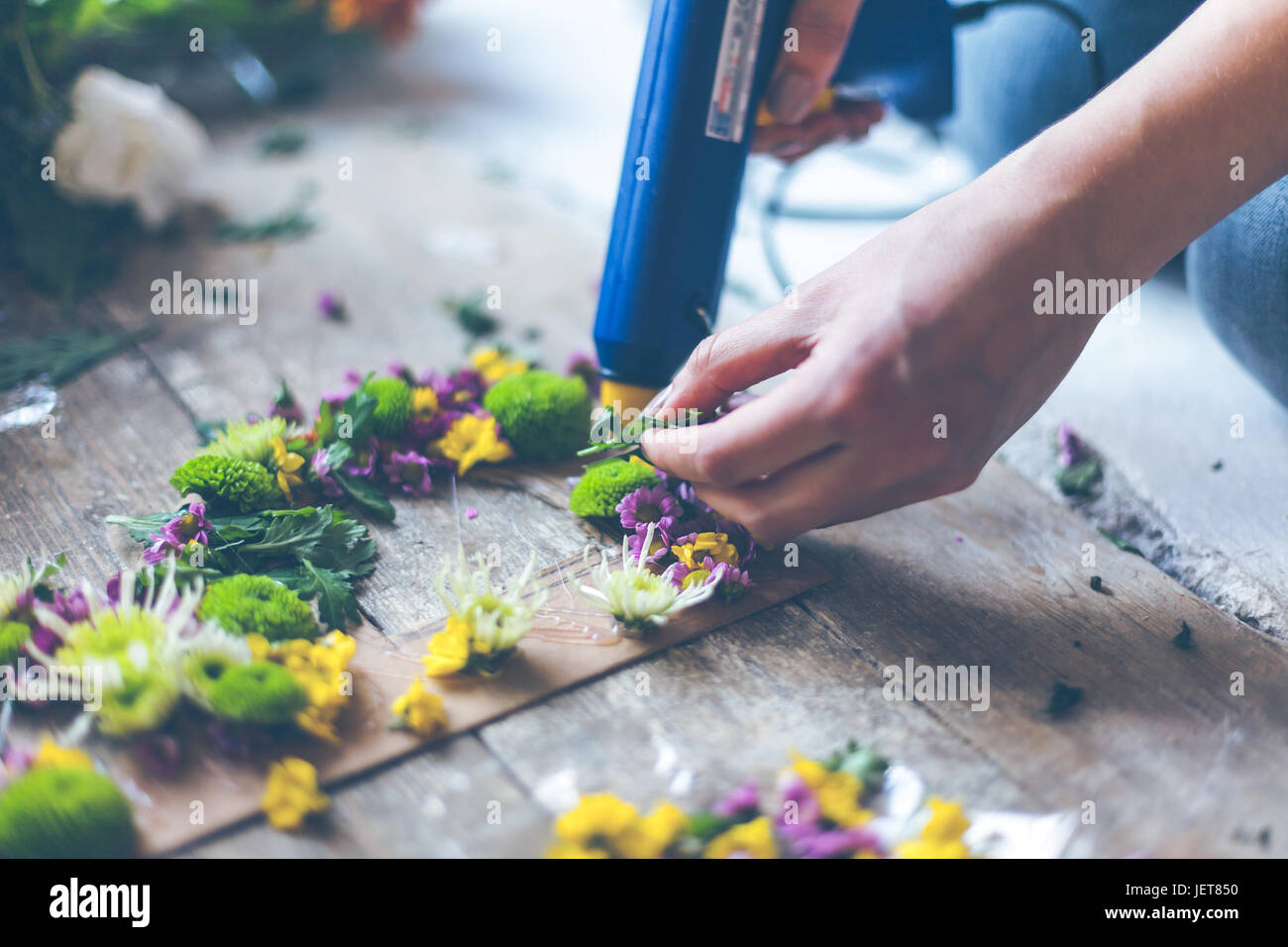 Florist making flower decoration with letters and glue. Indoors natural ...