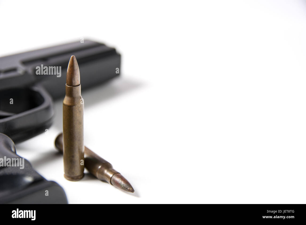 Hand gun sitting with m-16 bullets isolated on white background Stock ...