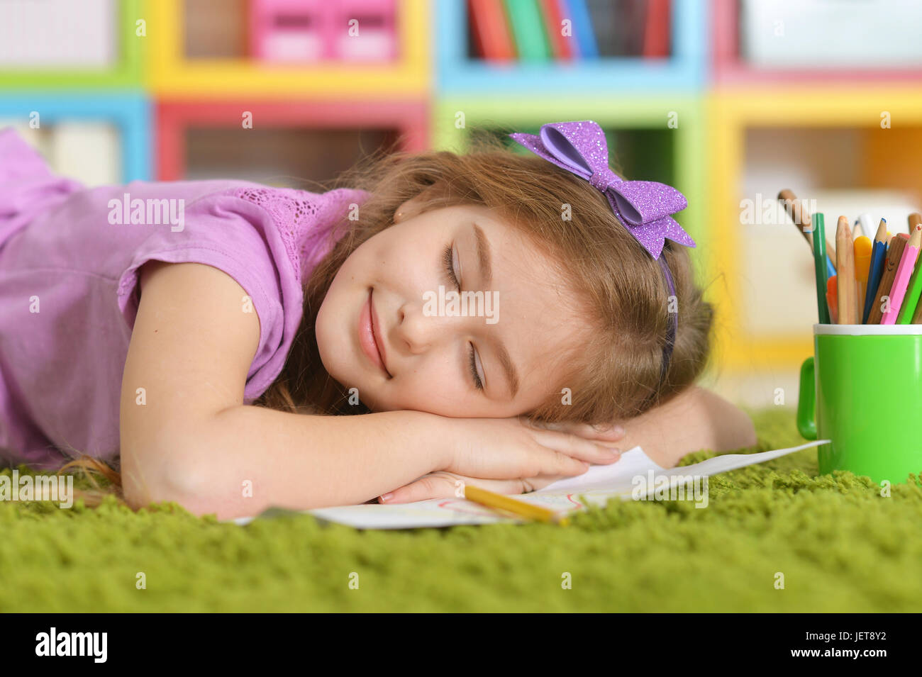 cute girl falling asleep after drawing at home Stock Photo - Alamy