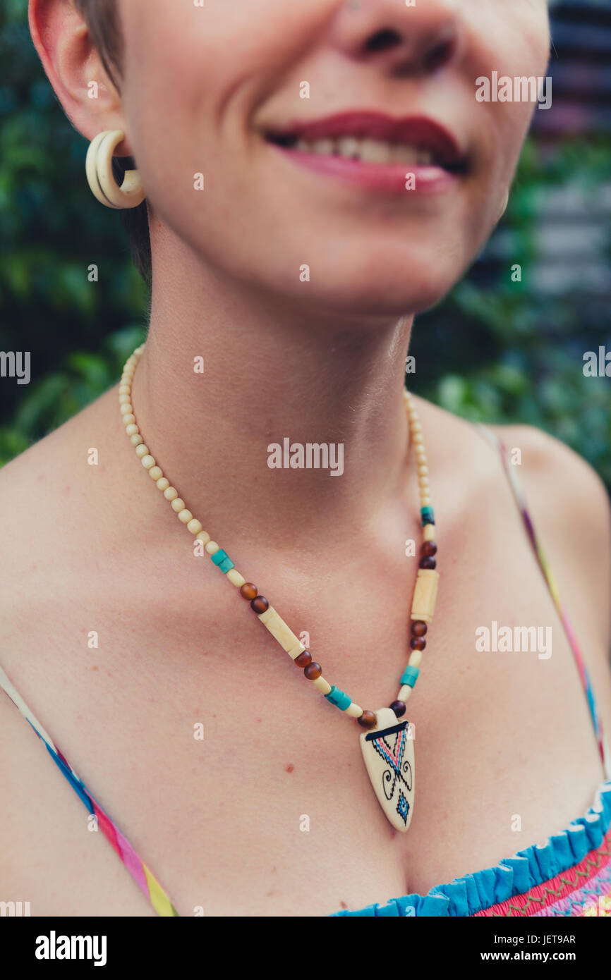 A young caucasian woman with androgynous features wears casual clothing ...