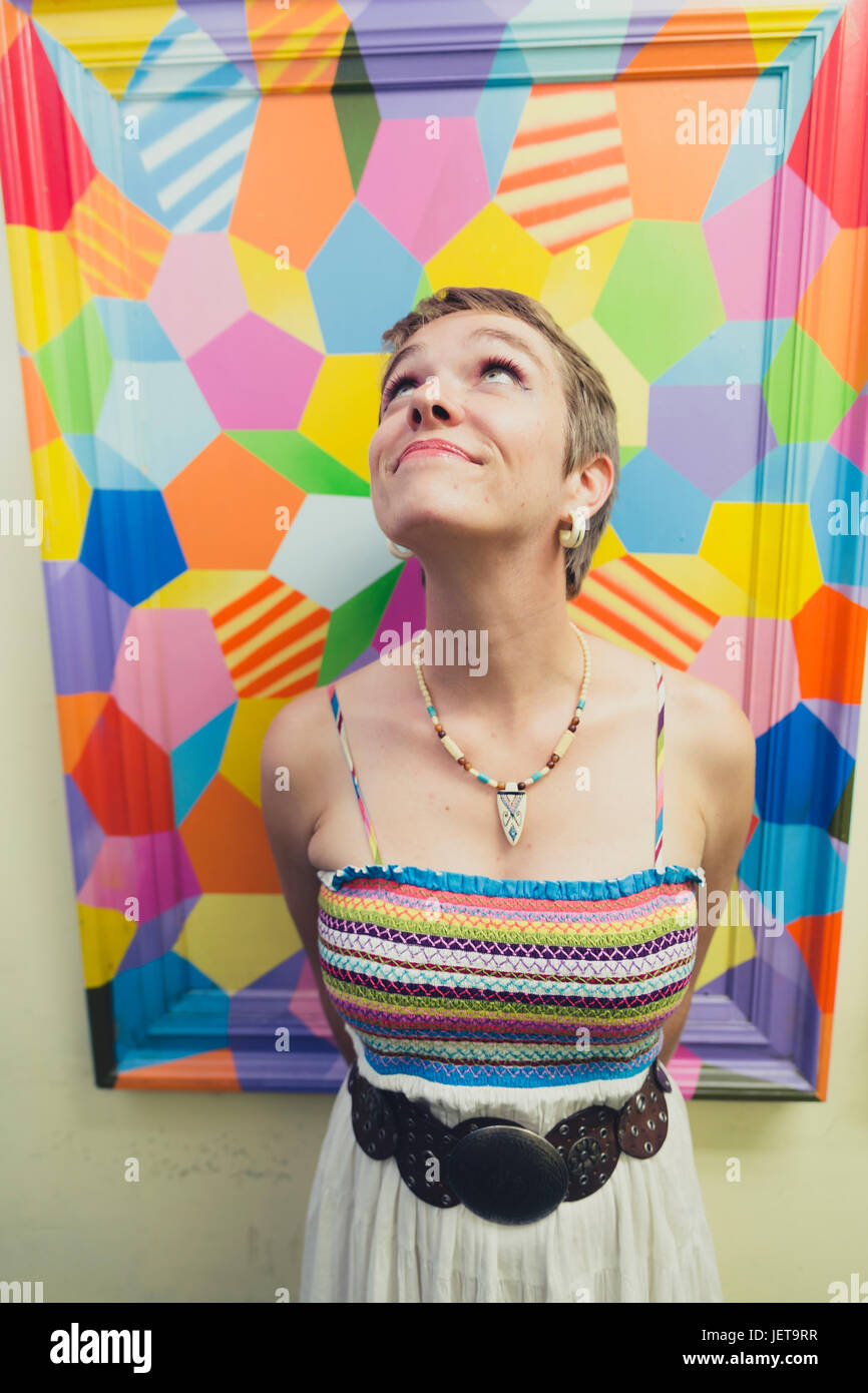 A young caucasian woman with androgynous features wears casual clothing ...